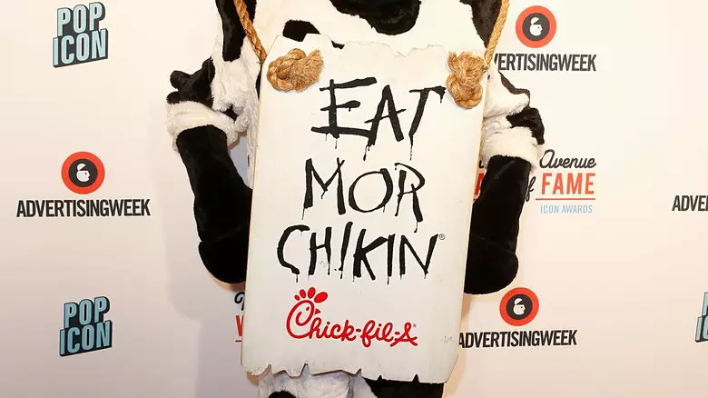 The Chick-fil-A cow with a sign