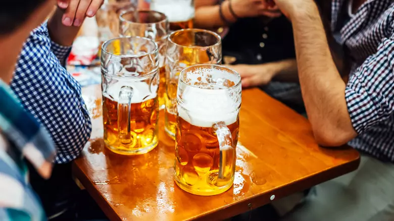 Cerveja em canecas em uma mesa de madeira