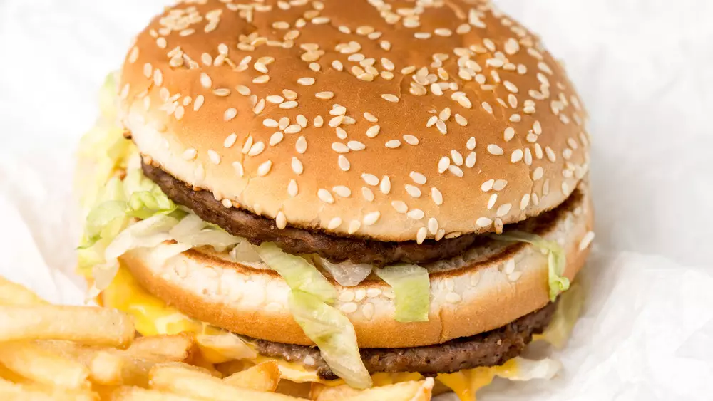 hamburger fast food su carta bianca con patatine fritte