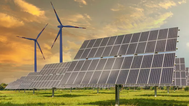 sonpaneel-skikkings en windturbines in grasveld