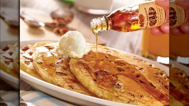 Pouring syrup on Cracker chim pecan pancakes