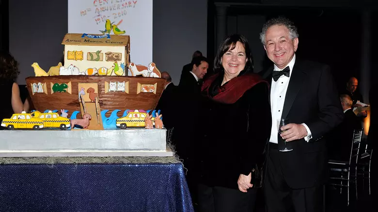 Ina y Jeffrey Garten de pie junto a un pastel en un evento benéfico