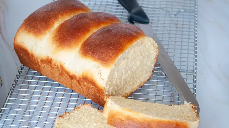 miche de pain au lait en tranches sur une grille de refroidissement