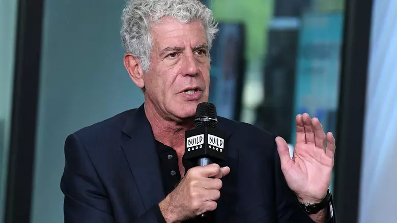 Anthony Bourdain berbicara ke mikrofon