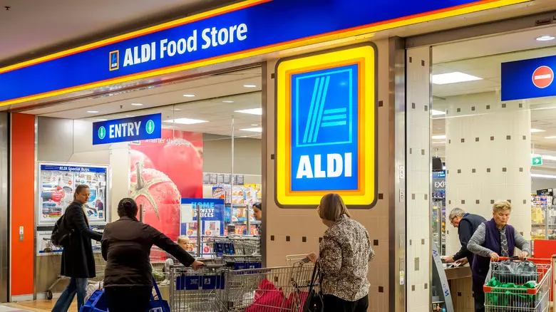 Aldi සාප්පුවෙන් පිටත කරත්ත සහිත පාරිභෝගිකයින්