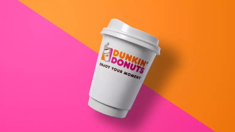 Cunca Dunkin' Donuts sobre fondo rosa e laranxa