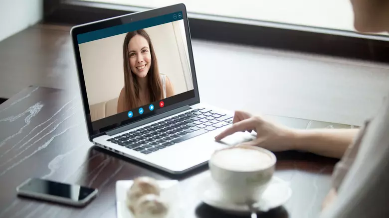 Person mit Webcam und Kaffee