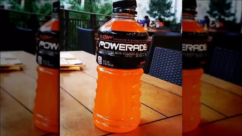 Fľaša Powerade Orange na vonkajšom stole