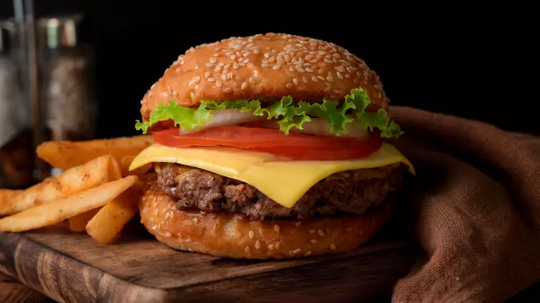 Un cheeseburger traditionnel au boeuf haché avec des frites