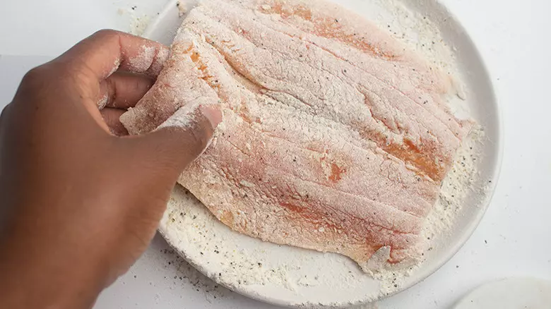 hand coating fish fillet