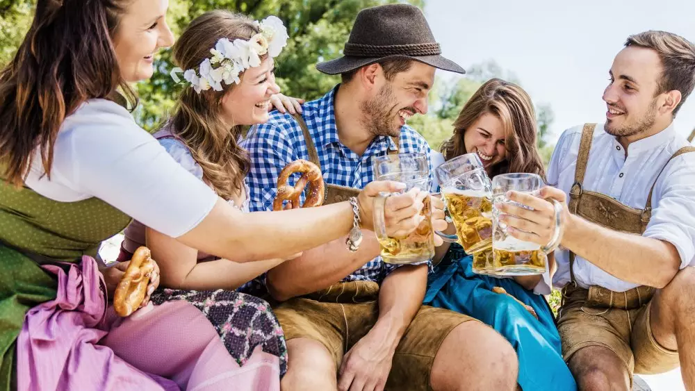 žmonių, pasipuošusių švęsti Oktoberfest su pintomis alaus