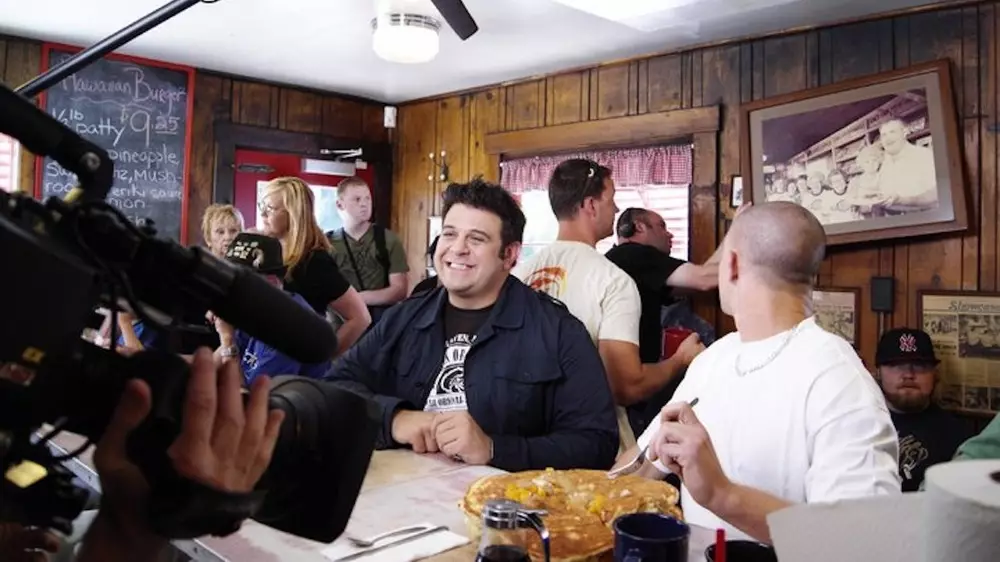 Adam Richman filmando en un restaurante