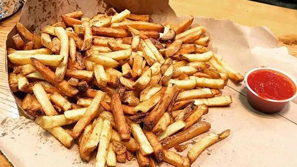 Eine Tüte Pommes kommt aus Five Guys