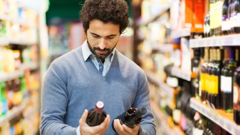 man-choosing-wine-in-store